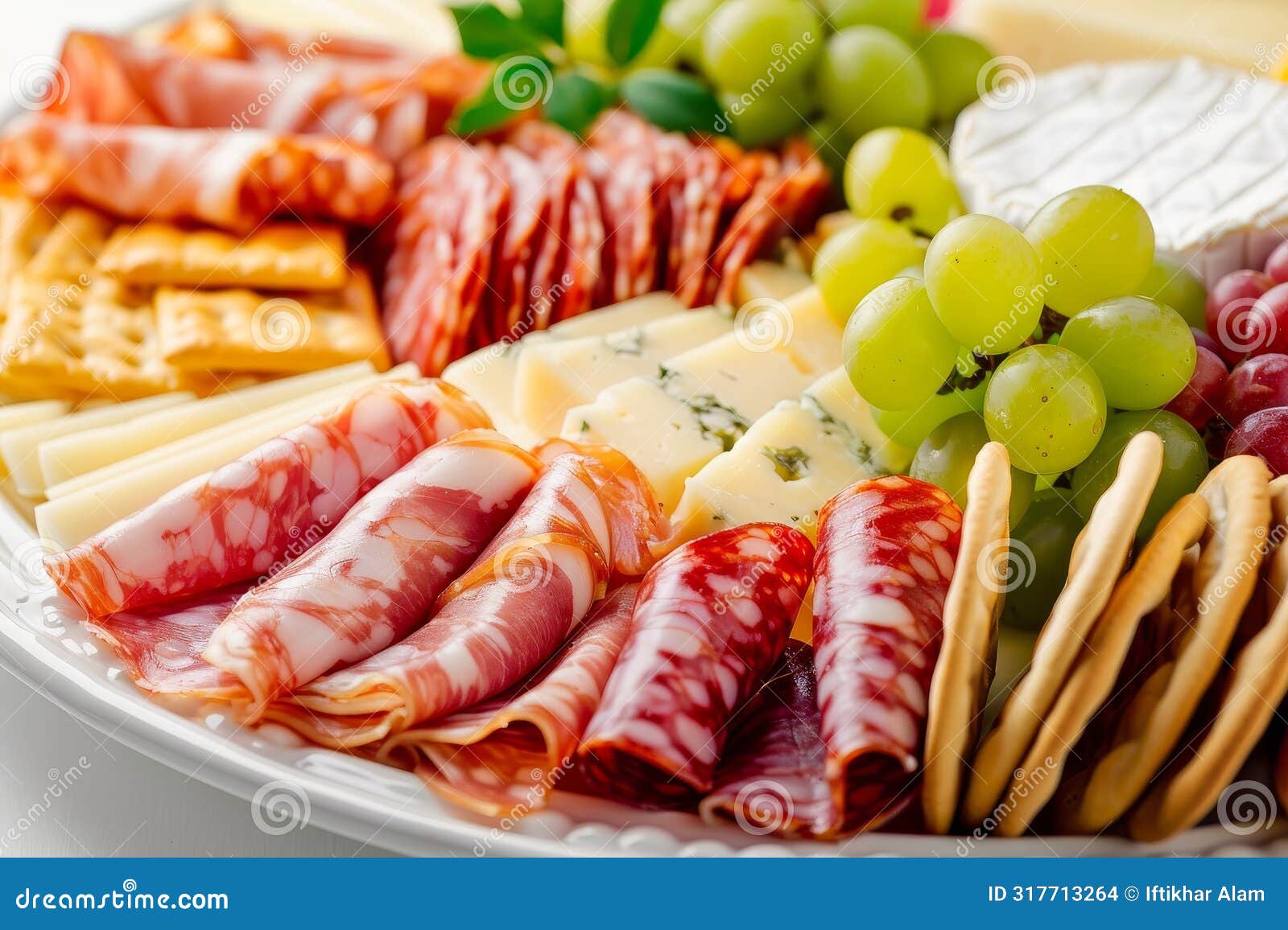 Assorted Cheese, Crackers, And Grapes On A Platter, A Platter Of ...