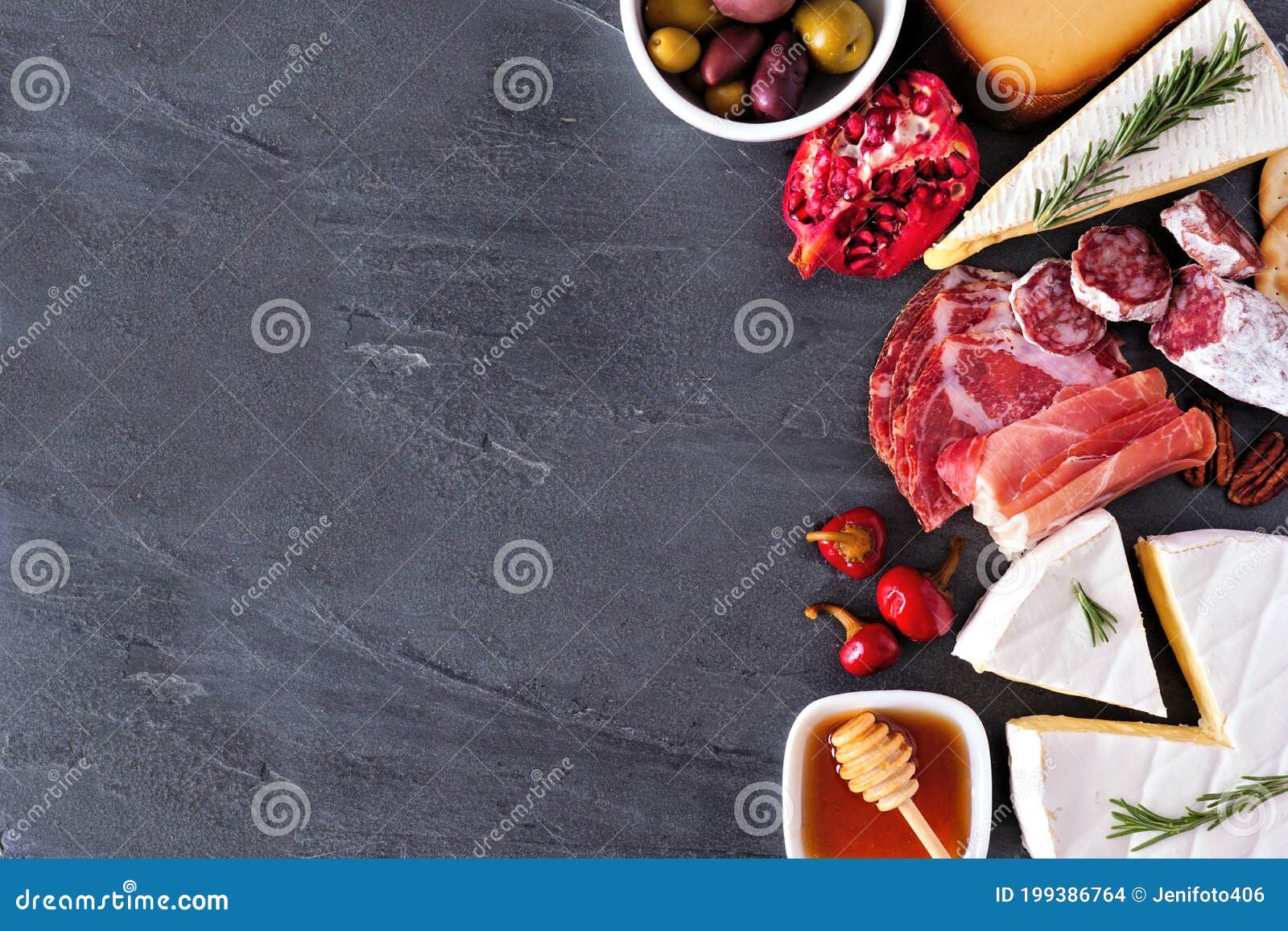 Assorted Cheese and Meat Appetizers, Side Border on a Dark Slate ...