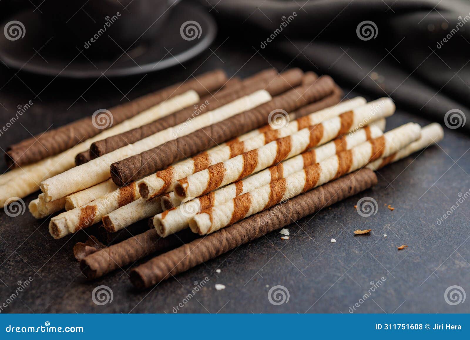 Assorted Chocolate and Vanilla Cream Filled Wafer Rolls on Dark Table ...