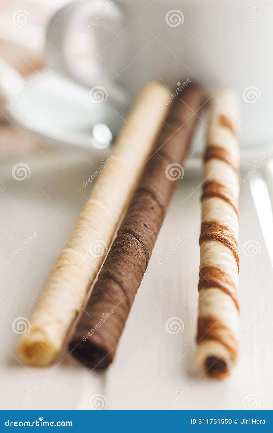 Assorted Chocolate and Vanilla Cream Filled Wafer Rolls on White Table ...
