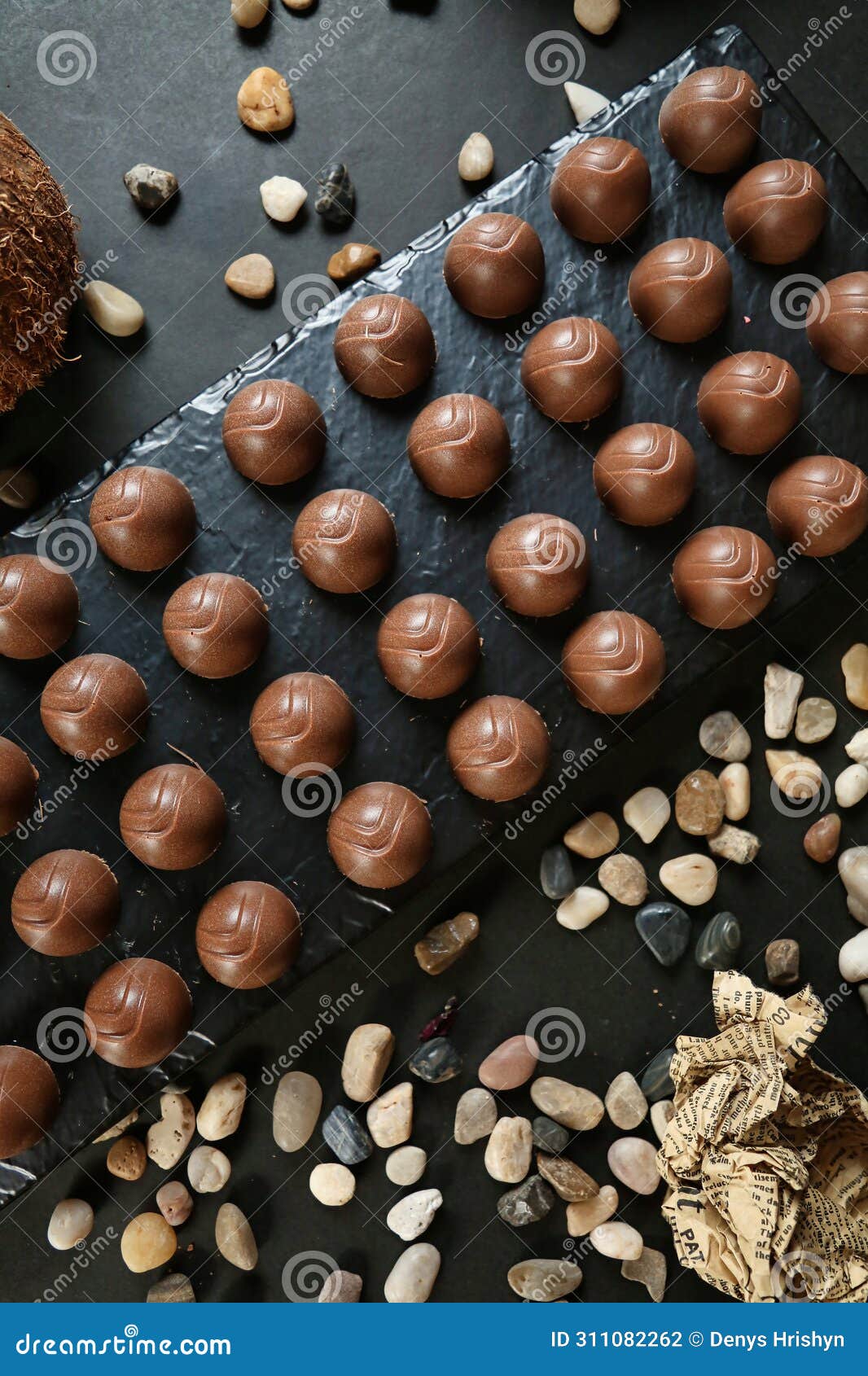 Assorted Chocolates and Nuts on a Black Surface Stock Photo - Image of ...
