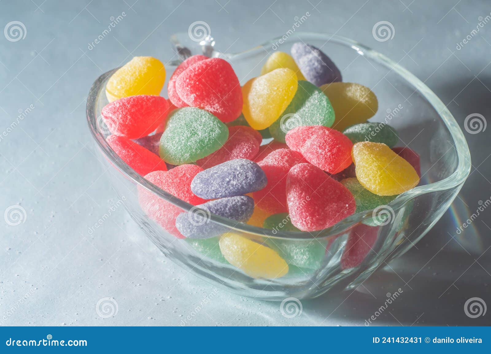 Assorted Colorful Sweets in a Trasparente Bowl, Light Blue Background ...