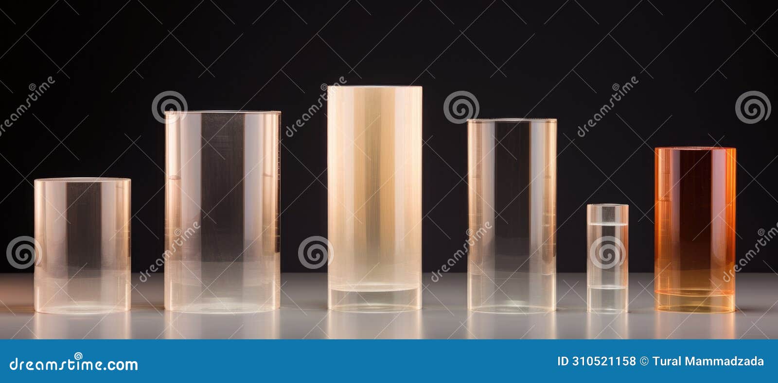 Various Cylinders Arranged on Table, Showcasing Different Sizes Stock ...