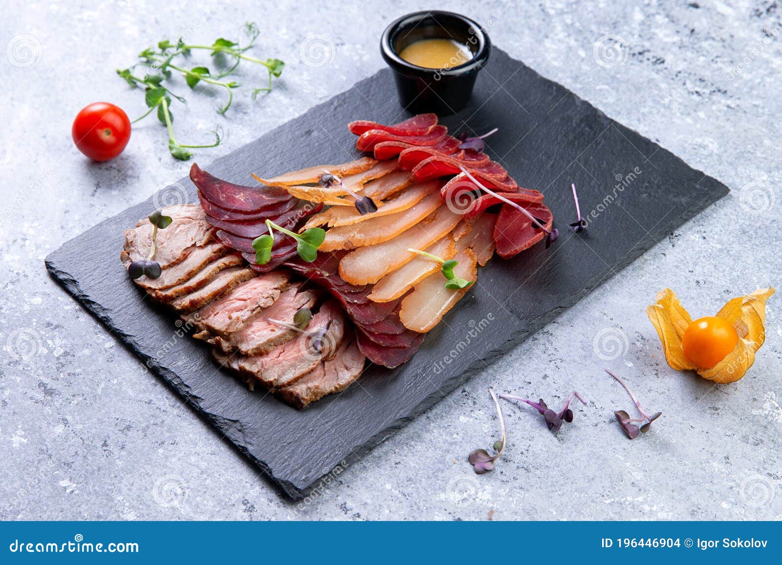 Assorted Dry-cured Meats on a Stone Background. Stock Photo - Image of ...