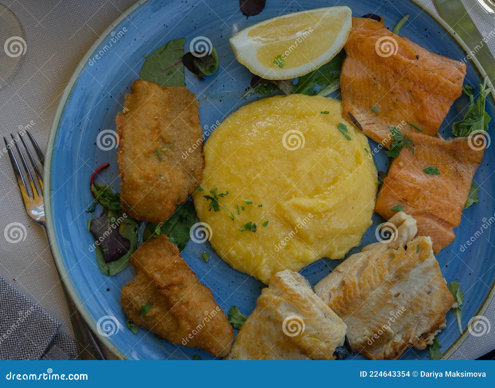 Assorted Fried Fish with Polenta on a Blue Plate Stock Photo - Image of ...