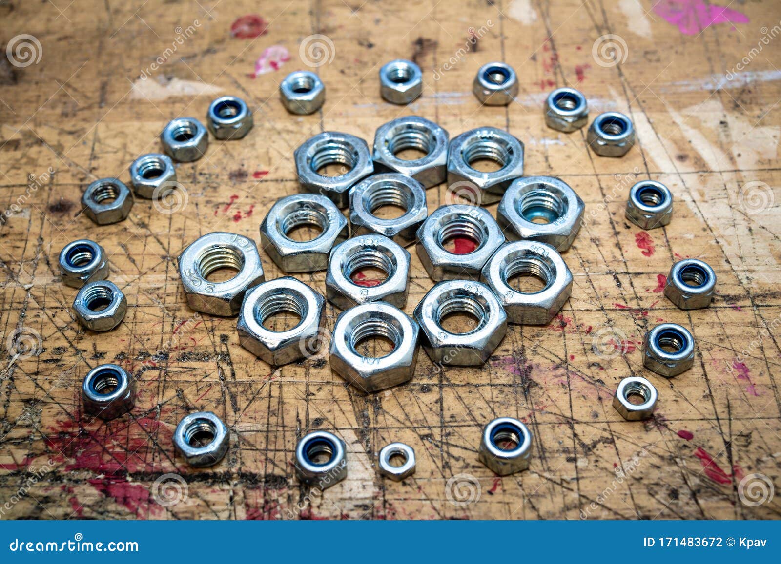 Assorted Metal Hex Nuts Shaping a Circle on Wooden Workbench Stained ...