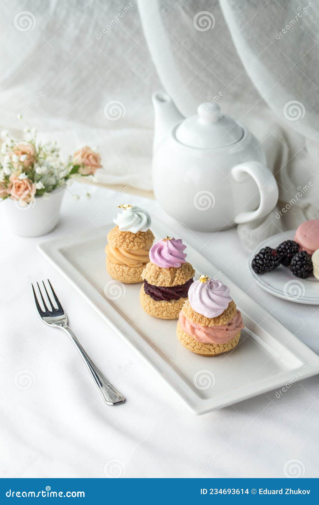 Assorted Miniature French Choux Pastry Dessert with Teapot on the Table ...