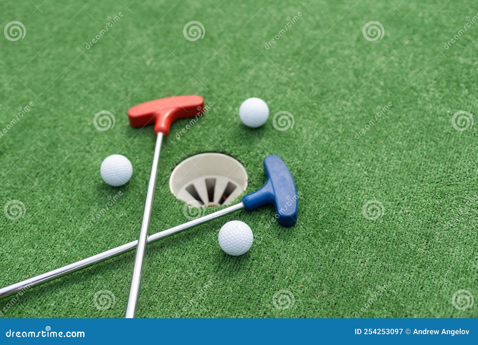 Assorted Miniature Golf Putters and Balls Askew on Synthetic Grass ...