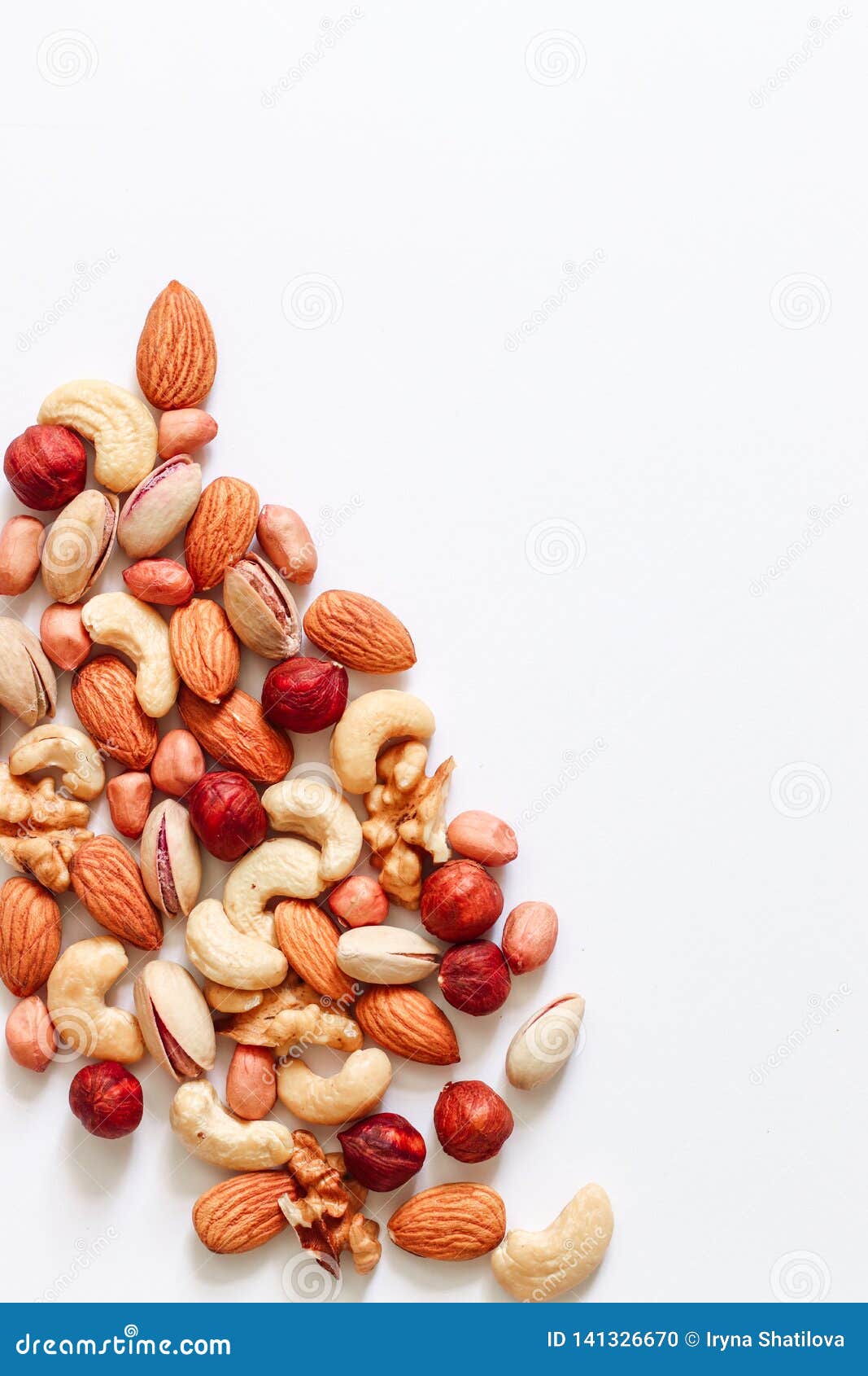 Assorted Nuts on a White Table. Hazelnuts, Cashews, Peanuts, Walnuts ...
