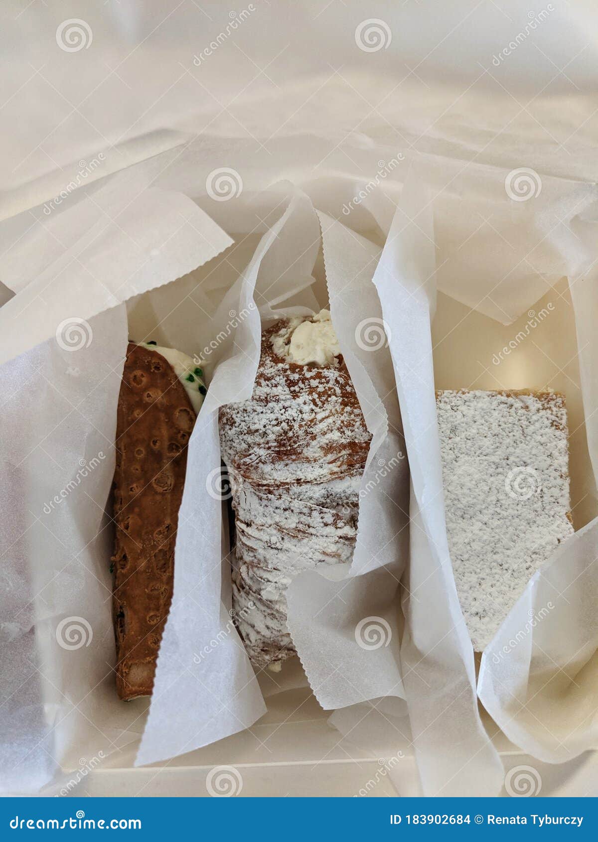 Assorted Pastries Separated by Paper in a Box Stock Photo - Image of ...