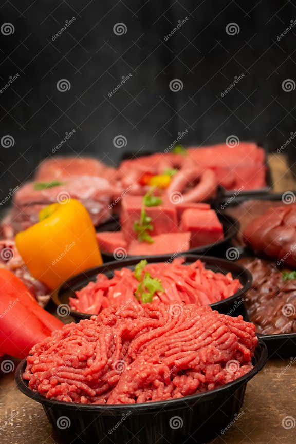 Assorted Raw Beef Meats on Table with Black Background Side View Stock ...