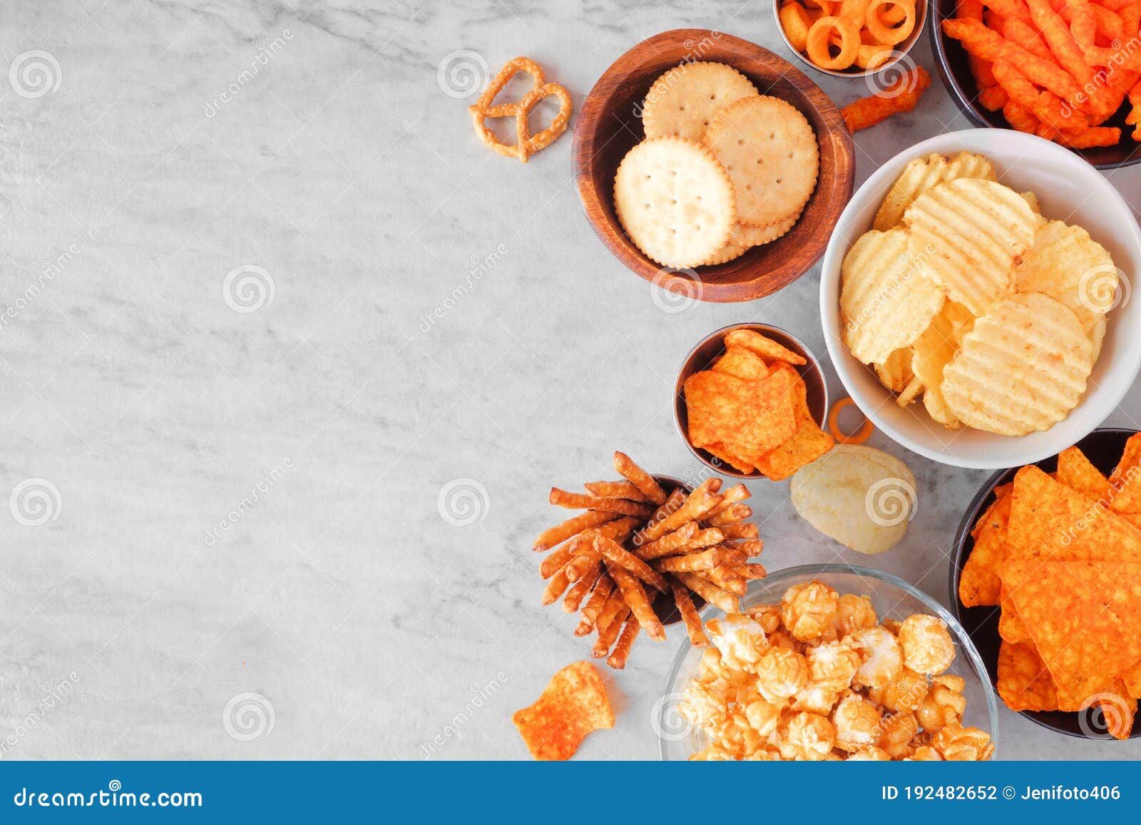 Assorted Salty Snacks, Top Down Side Border On A Grey Stone Background ...