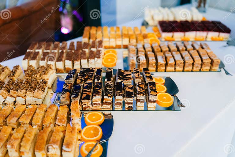 Assorted Selection of Cake Pieces, and Desserts in Trays Stock Photo ...