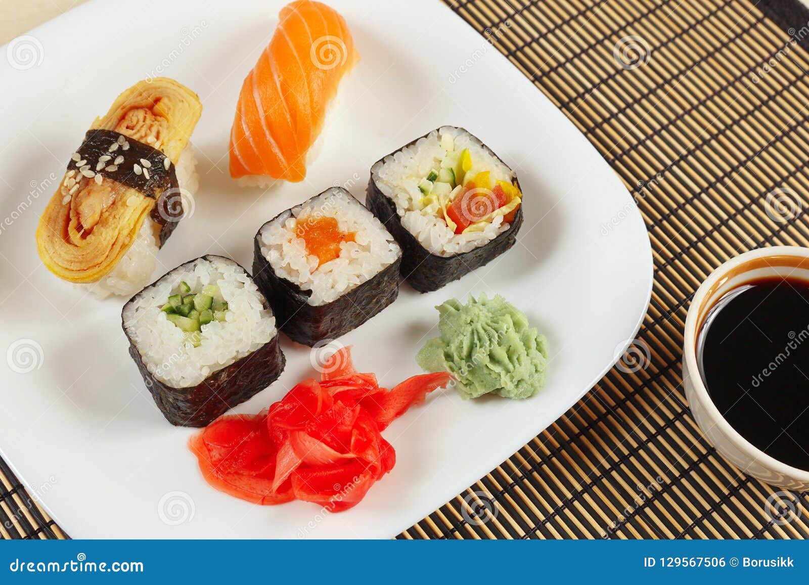 Assorted Sushi and Rolls and Soy Sauce on Bamboo Makisu Close Up. Stock ...