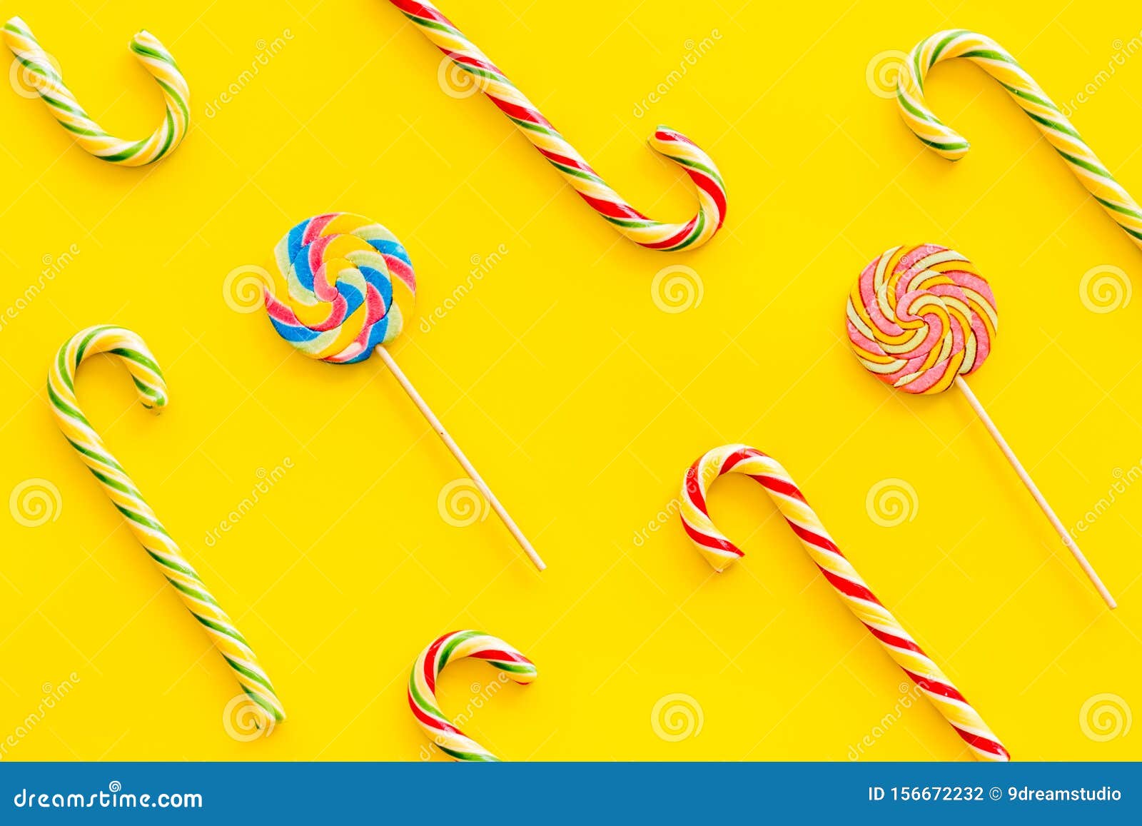Assorted Sweets, Lollipop and Candy Cane on Yellow Background Top View ...