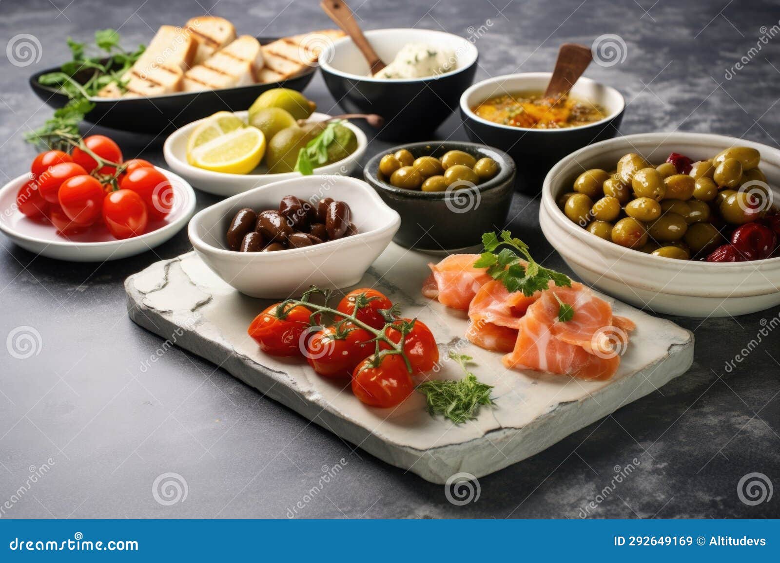 Assorted Tapas in White Ceramic Dishes Against a Stone Backdrop Stock ...