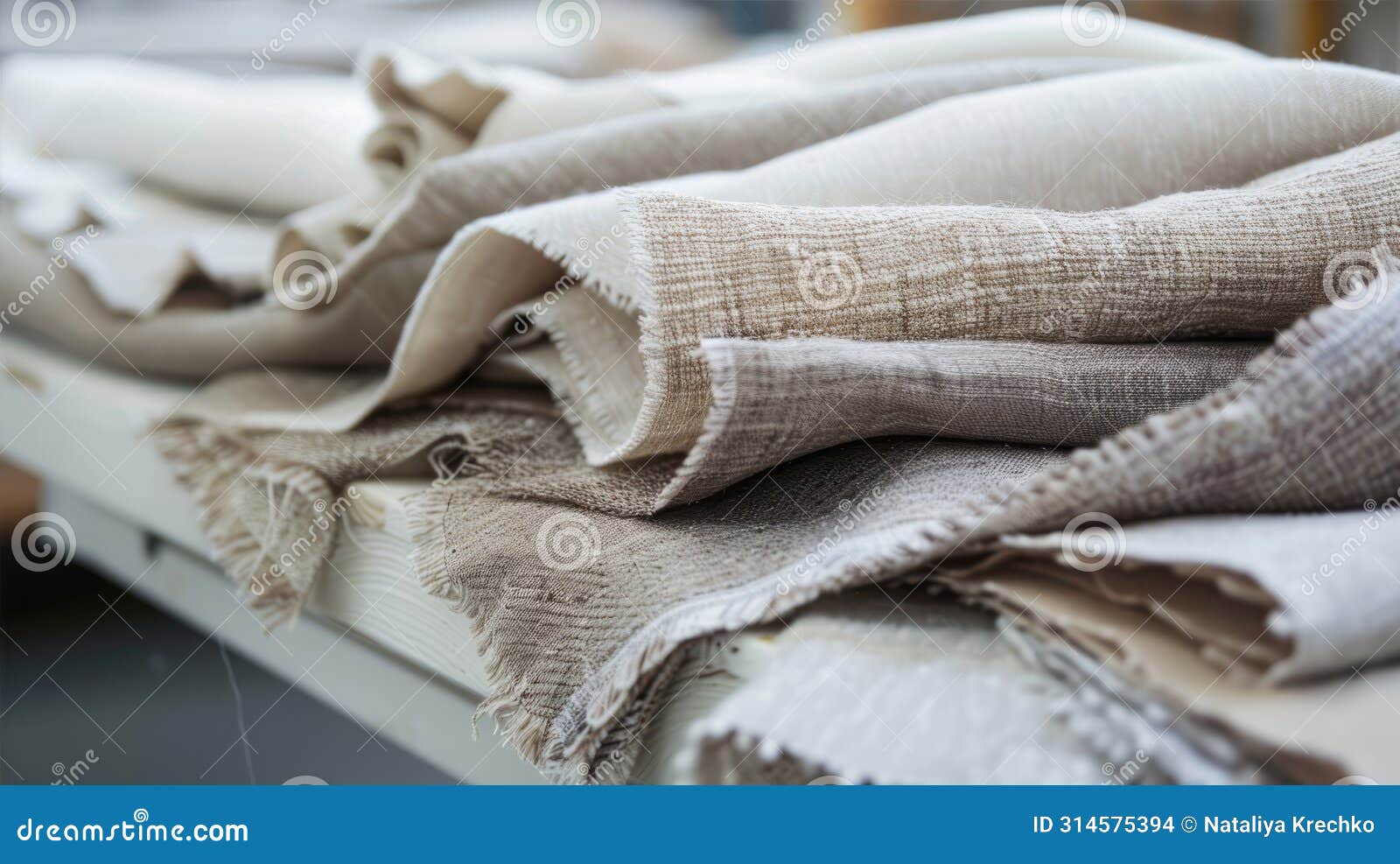 Assorted Textiles in Grey and Brown Stacked on Wood Table Stock Photo ...