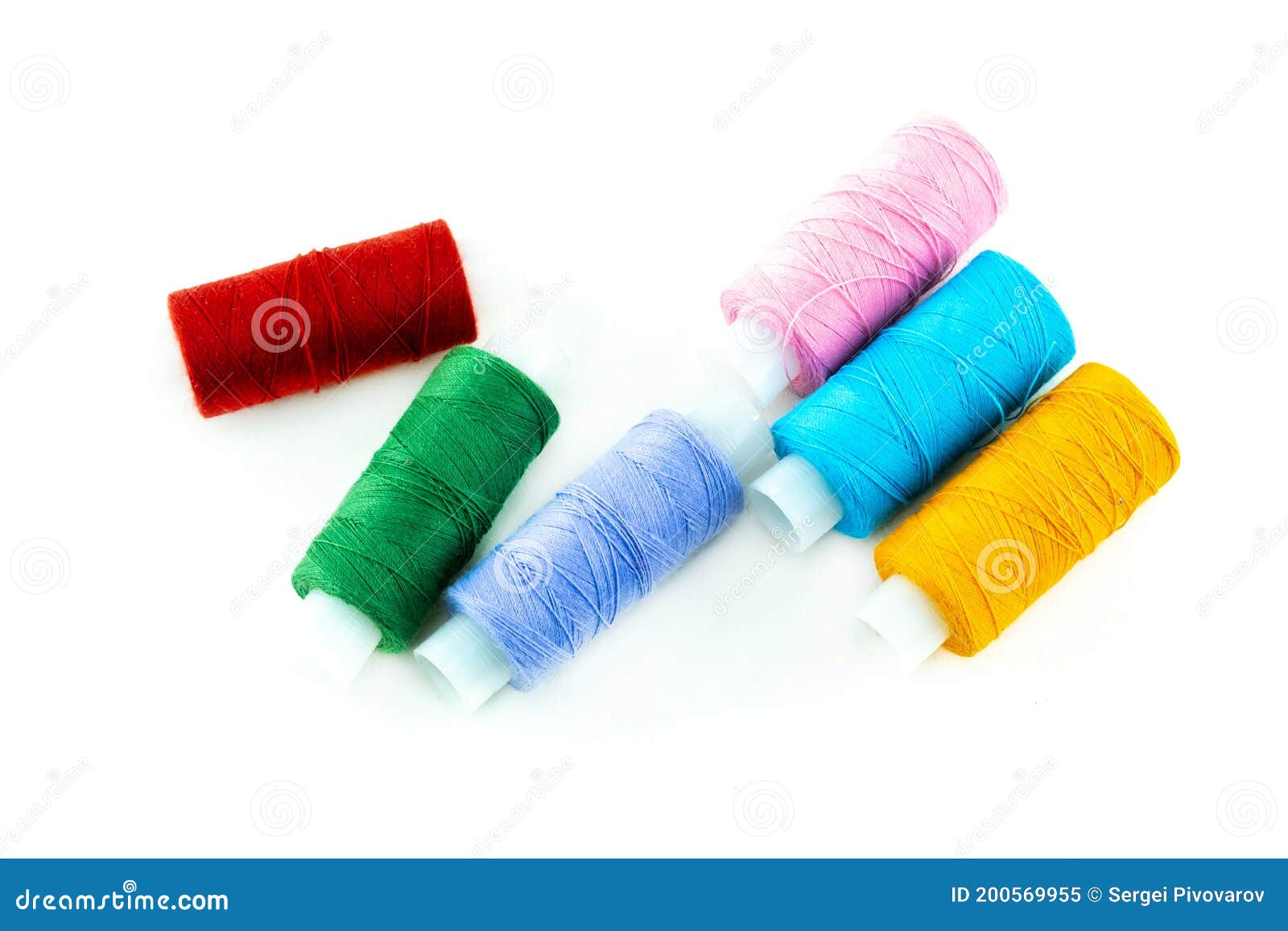 Assorted Threads in Red, Green and Blue Bobbins on an Isolated ...