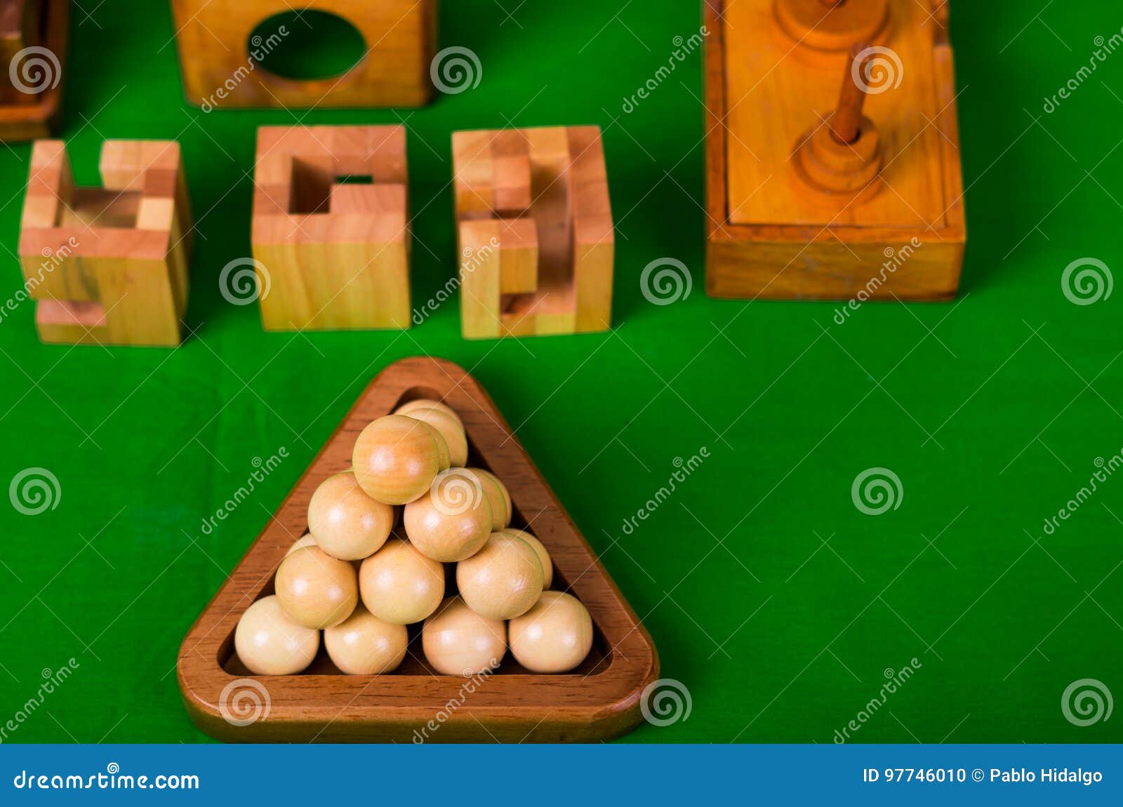 Assorted Wooden Brain Teaser or Wooden Puzzles on Green Background ...