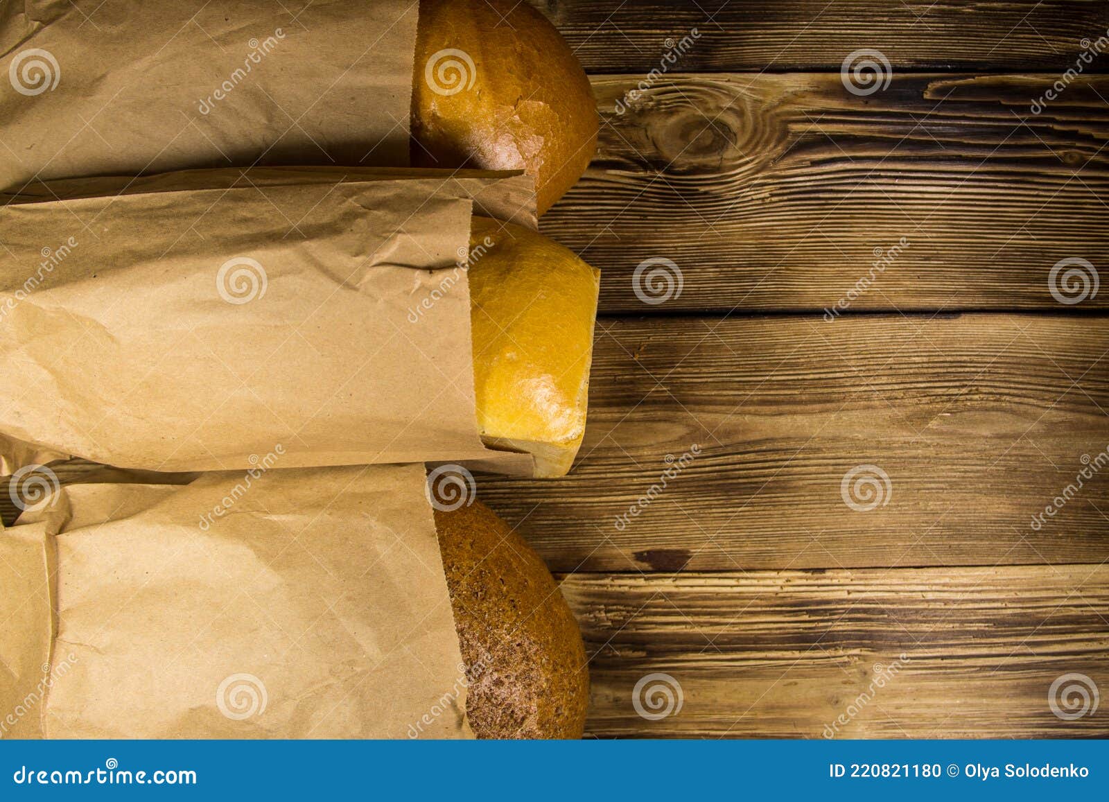 Assortment of Bread Packed in Paper on Wooden Table Stock Photo - Image ...
