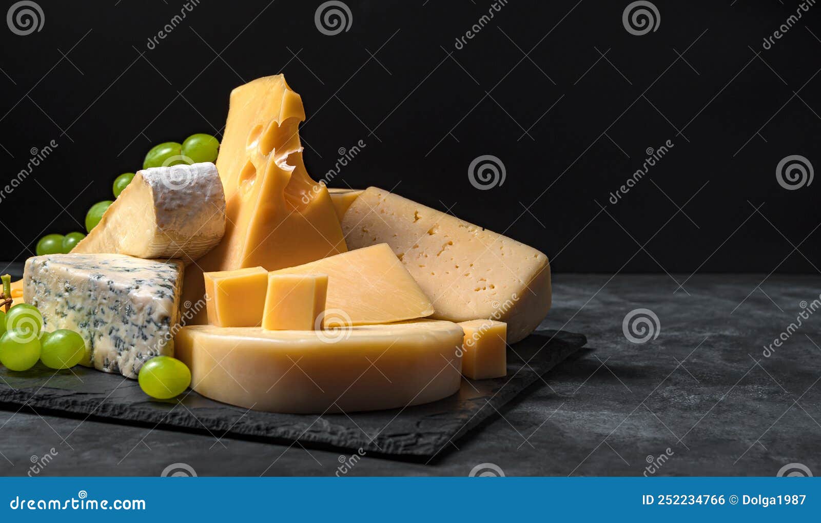 Assortment of Different Types of Cheeses on a Black Background. Stock ...