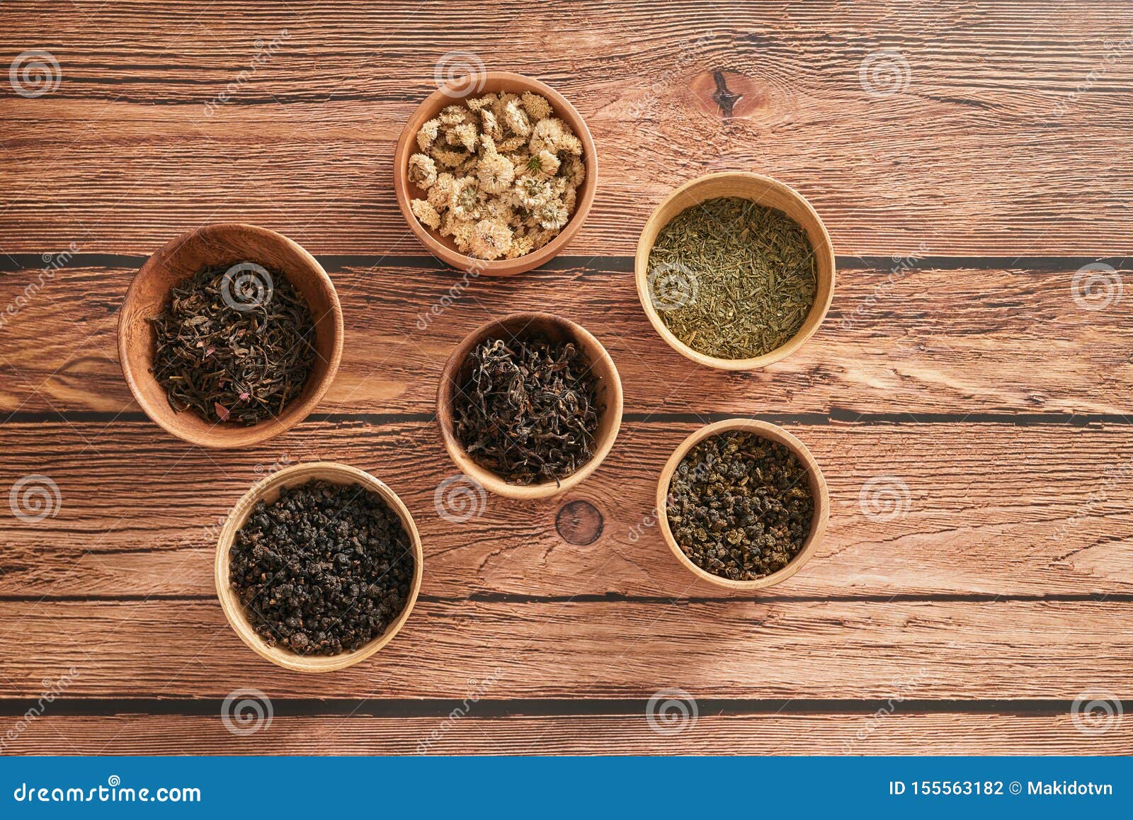 Assortment of Dry Tea in White Bowls on Wooden Surface Stock Photo ...
