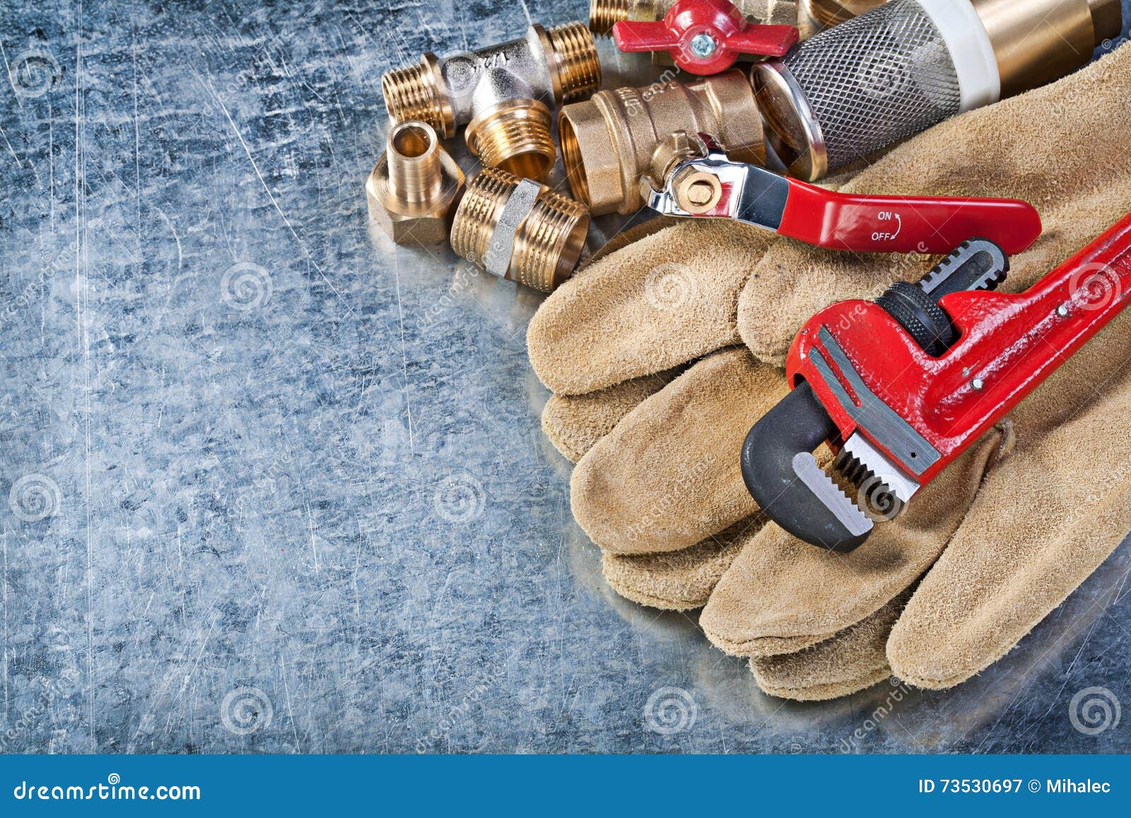 Assortment of Plumbing Brass Hardware Safety Gloves on Metallic Stock ...