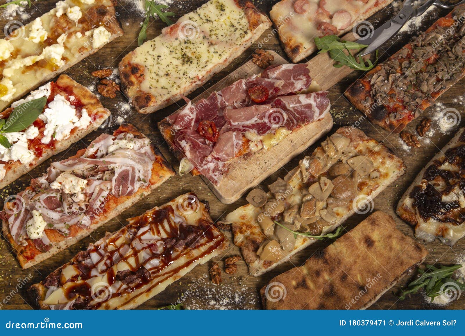 Assortment of Rectangular Homemade Rustic Pizza Slices on Wooden Table ...
