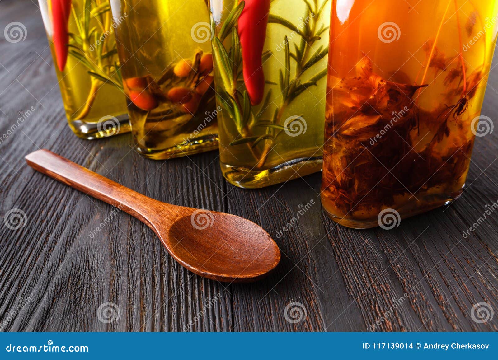 Assortment of Spicy Oils with Herbs and Spices in Different Bottles ...