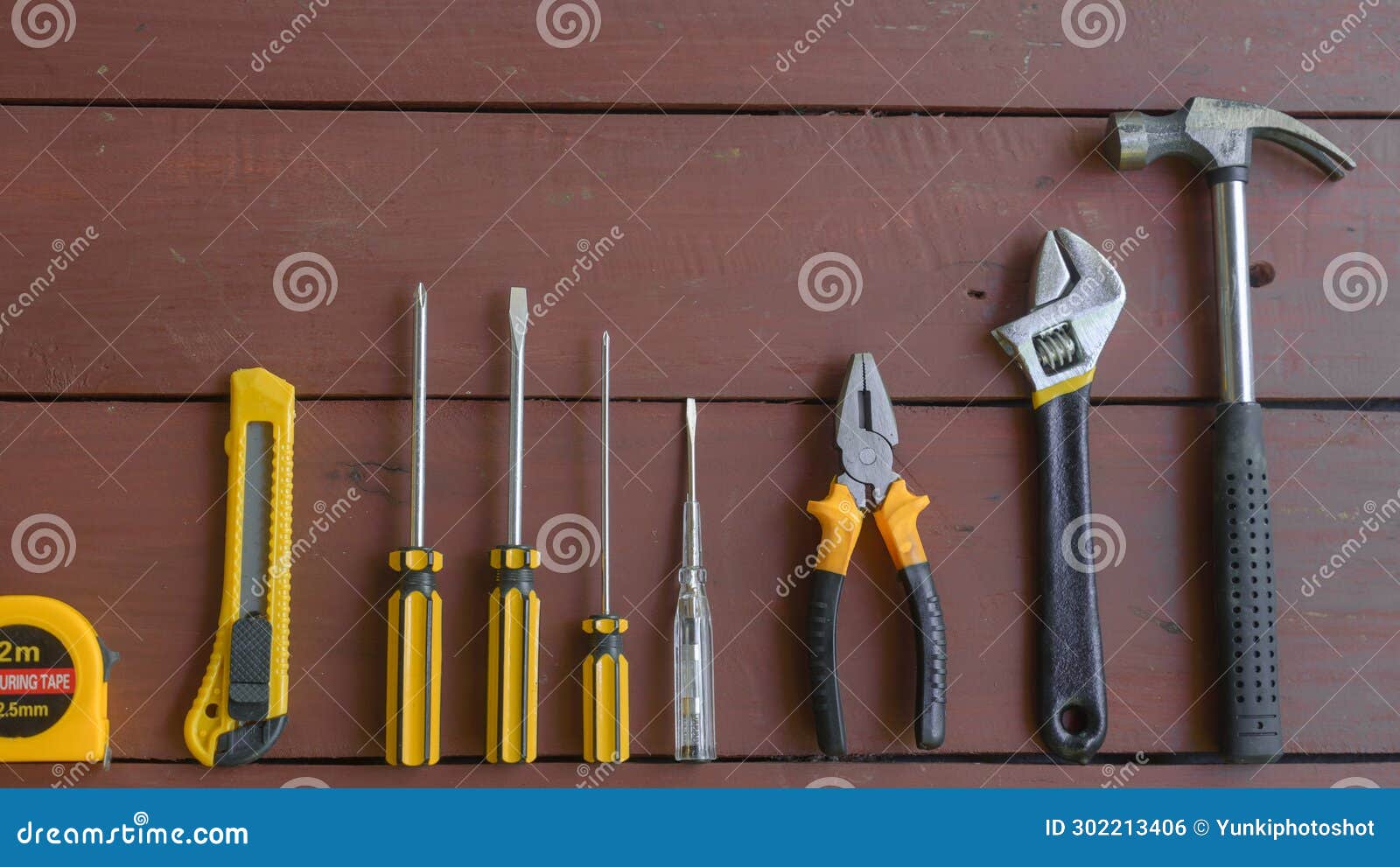 Assortment of Well-used Hand Tools Spread Out on a Worn Wooden Surface ...