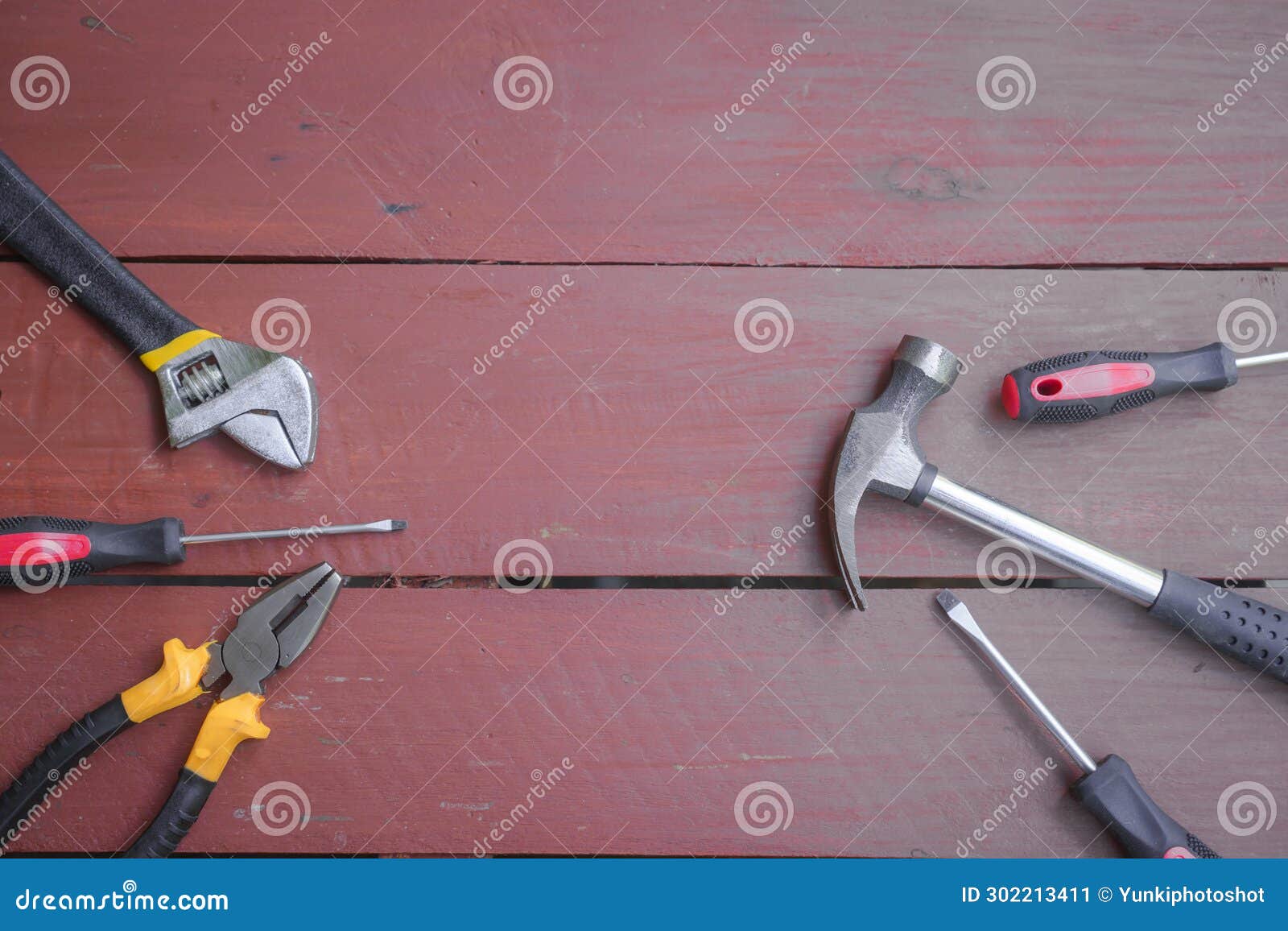 Assortment of Well-used Hand Tools Spread Out on a Worn Wooden Surface ...