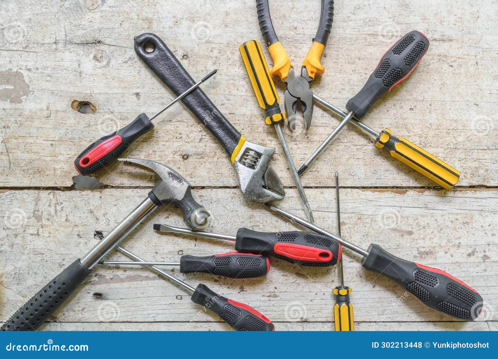 Assortment of Well-used Hand Tools Spread Out on a Worn Wooden Surface ...