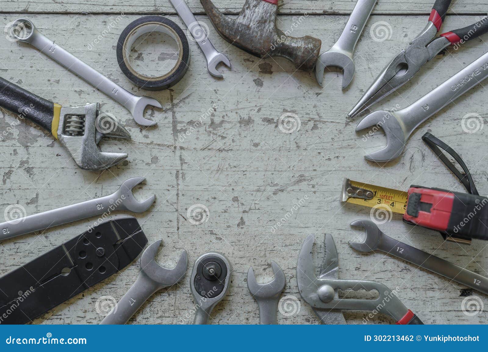 Assortment of Well-used Hand Tools Spread Out on a Worn Wooden Surface ...