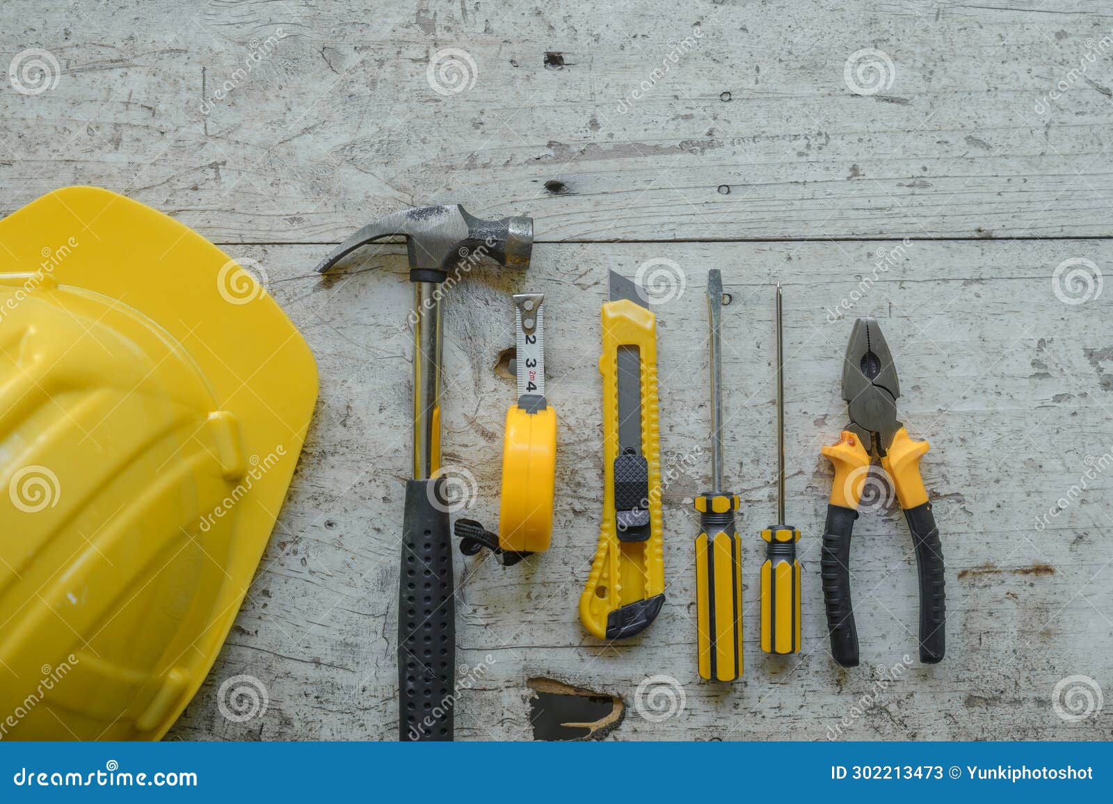 Assortment of Well-used Hand Tools Spread Out on a Worn Wooden Surface ...