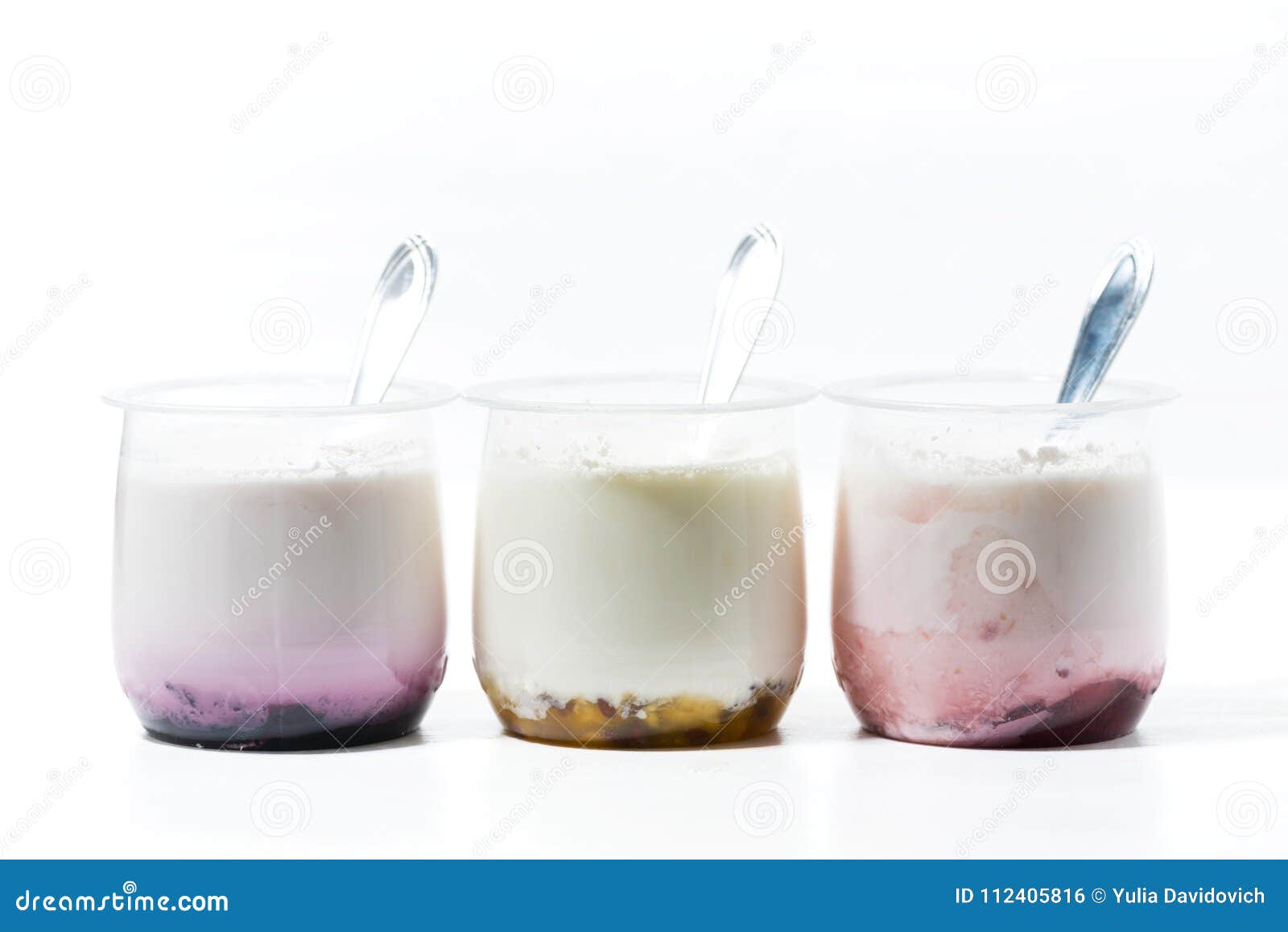 Assortment of Yogurts with Fruit Additives on White Table Stock Photo ...