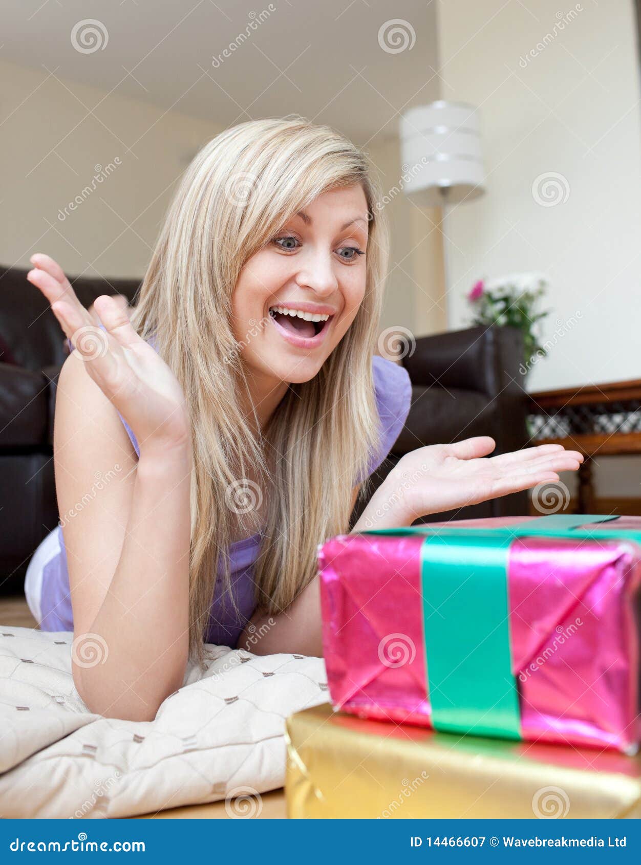 Astonished Woman Looking at a Present Stock Image - Image of couch ...