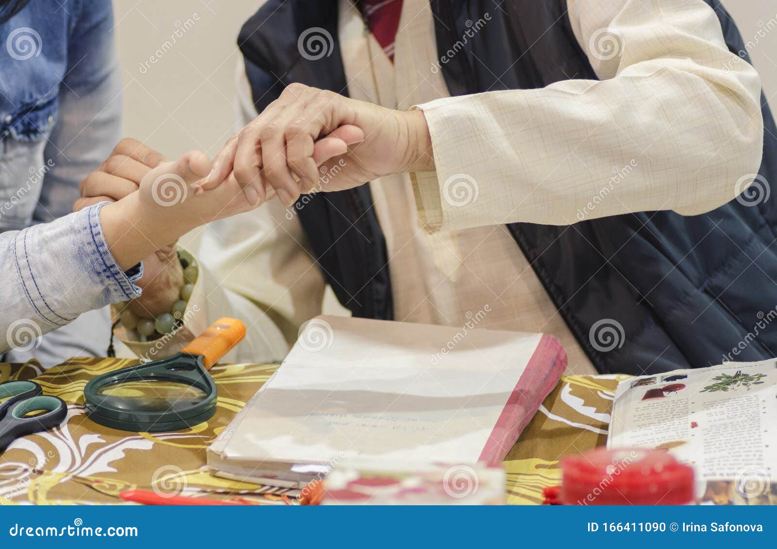 Astrologer-palmist Conducts a Study of the Hand of the Client and Makes ...