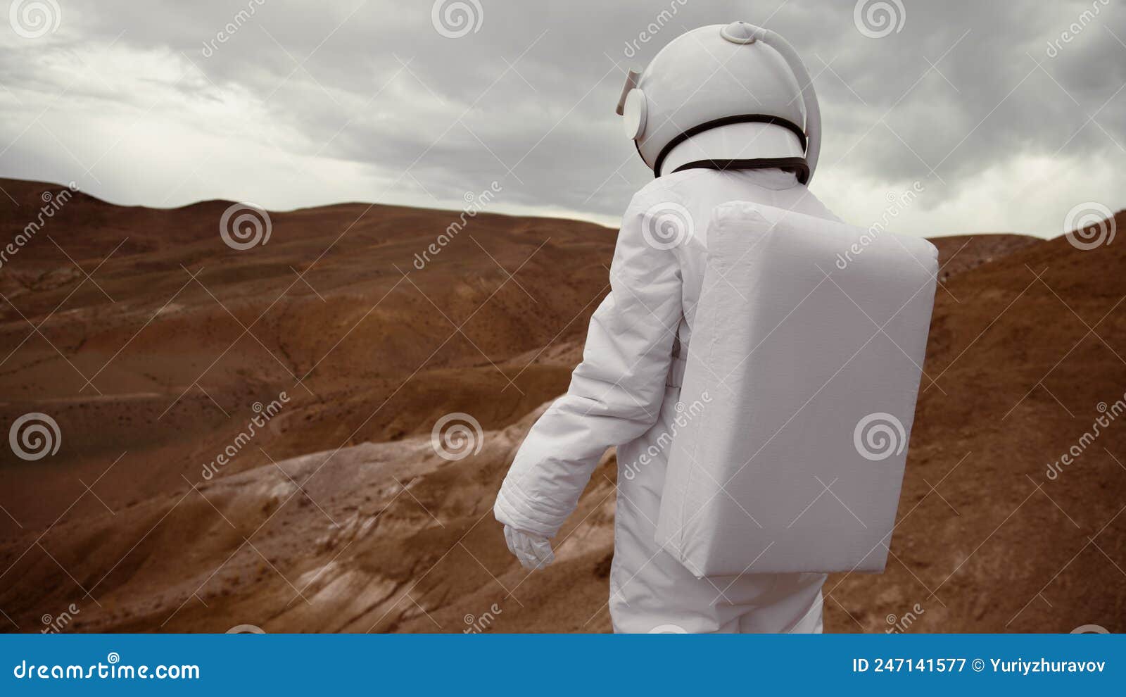 Astronaut Explores an Unknown Red Planet. Cloudy Sky and Mountains in ...