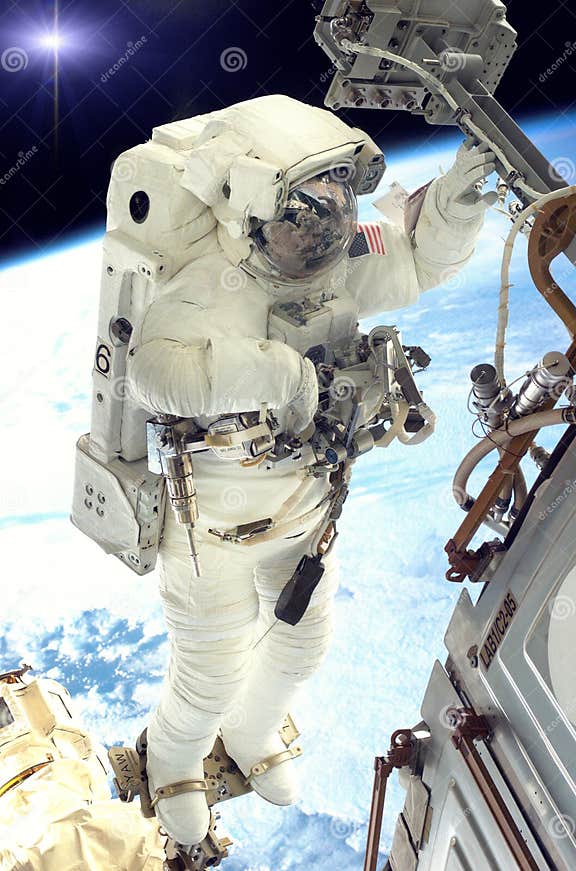 Astronaut is Fixing Something in Outer Space. Elements Furnished by ...