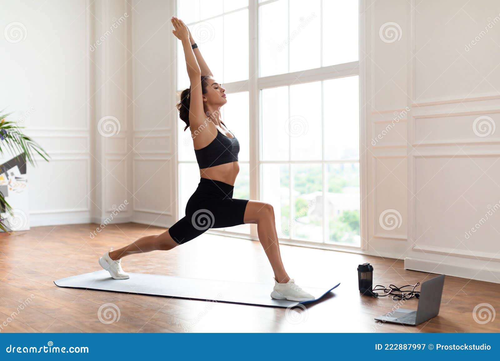 Young Woman Doing Forward Lunges in Front of Laptop Stock Image - Image ...