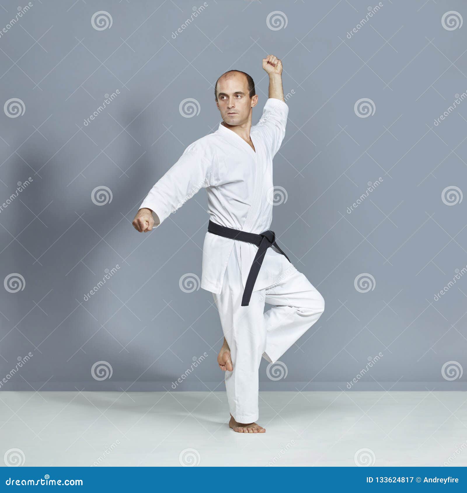 Athlete with a Black Belt and White Karategi Performs Formal Karate ...