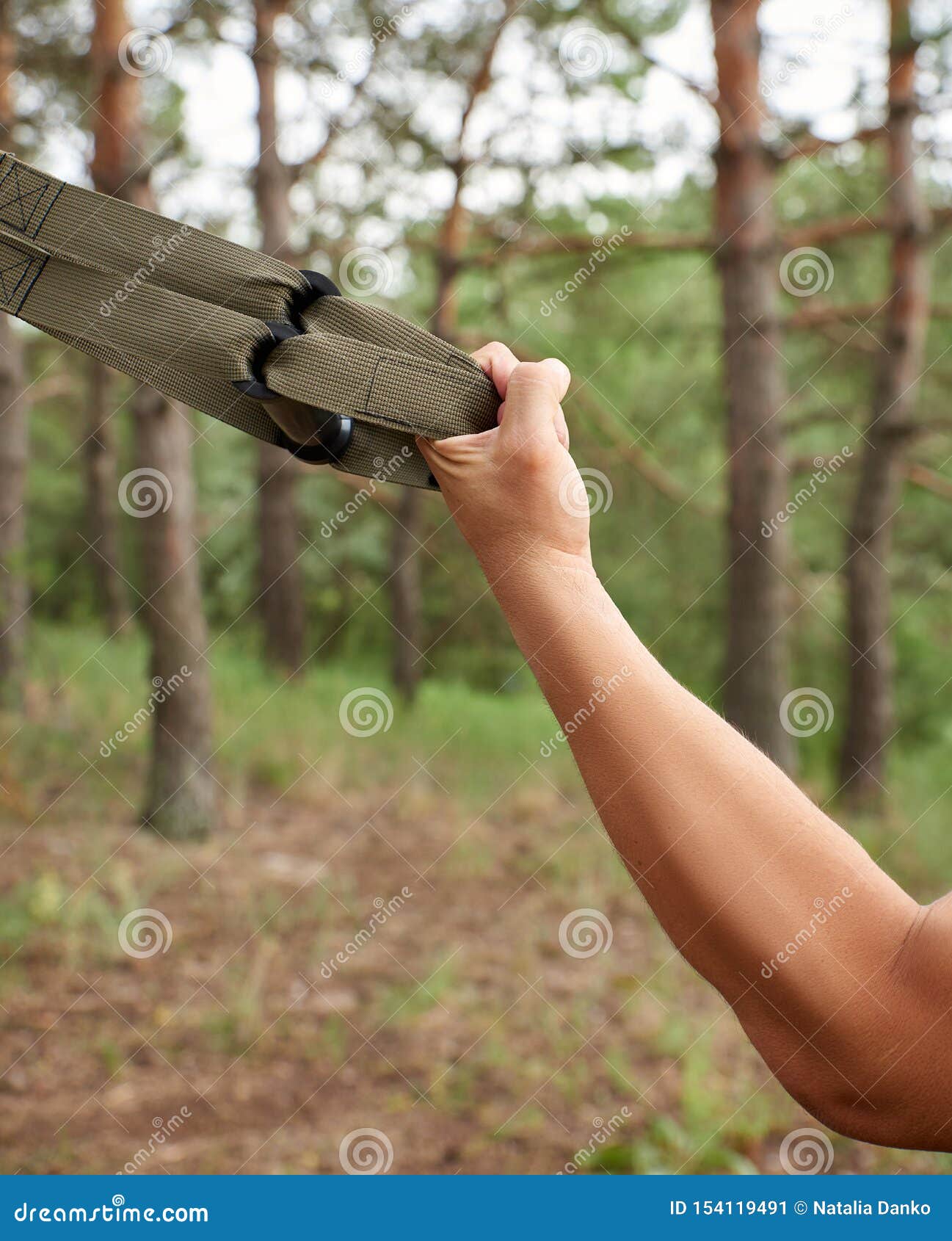 Athlete in Black Uniform Does Strength Exercises with a Tethered Rope ...