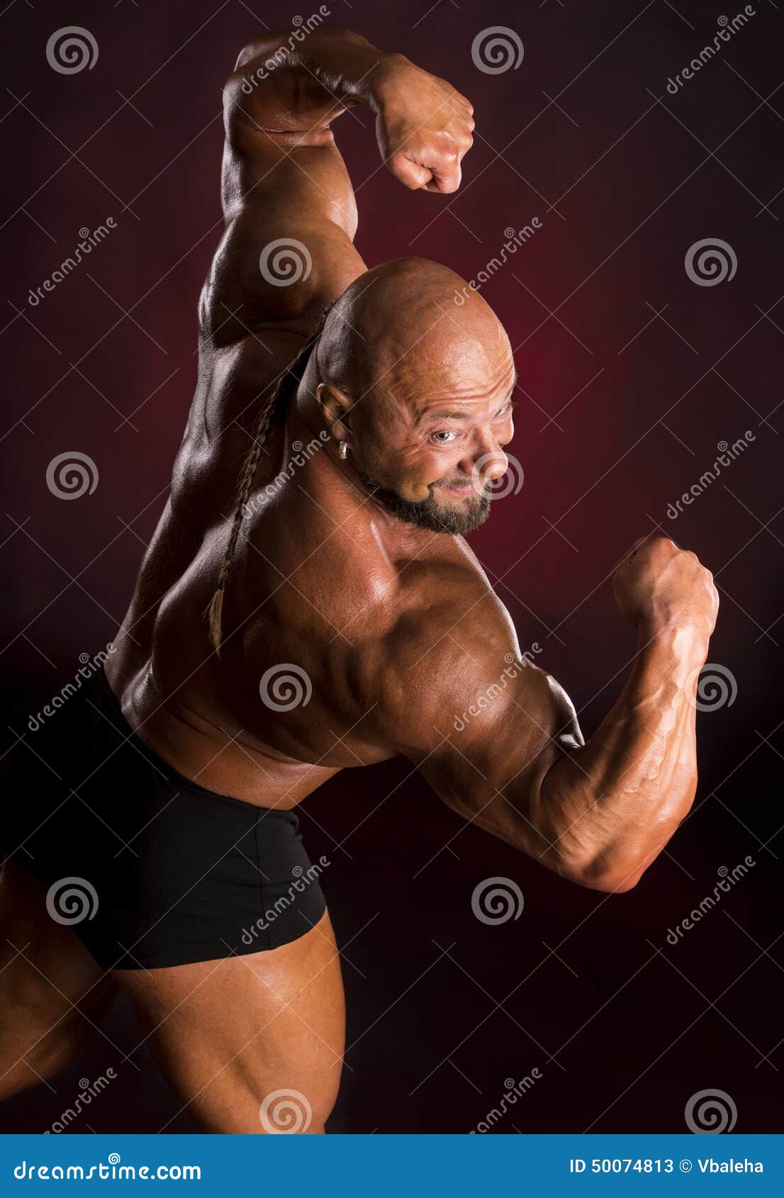 Athlete Bodybuilder Demonstrating Muscles of the Back and Arms Stock ...