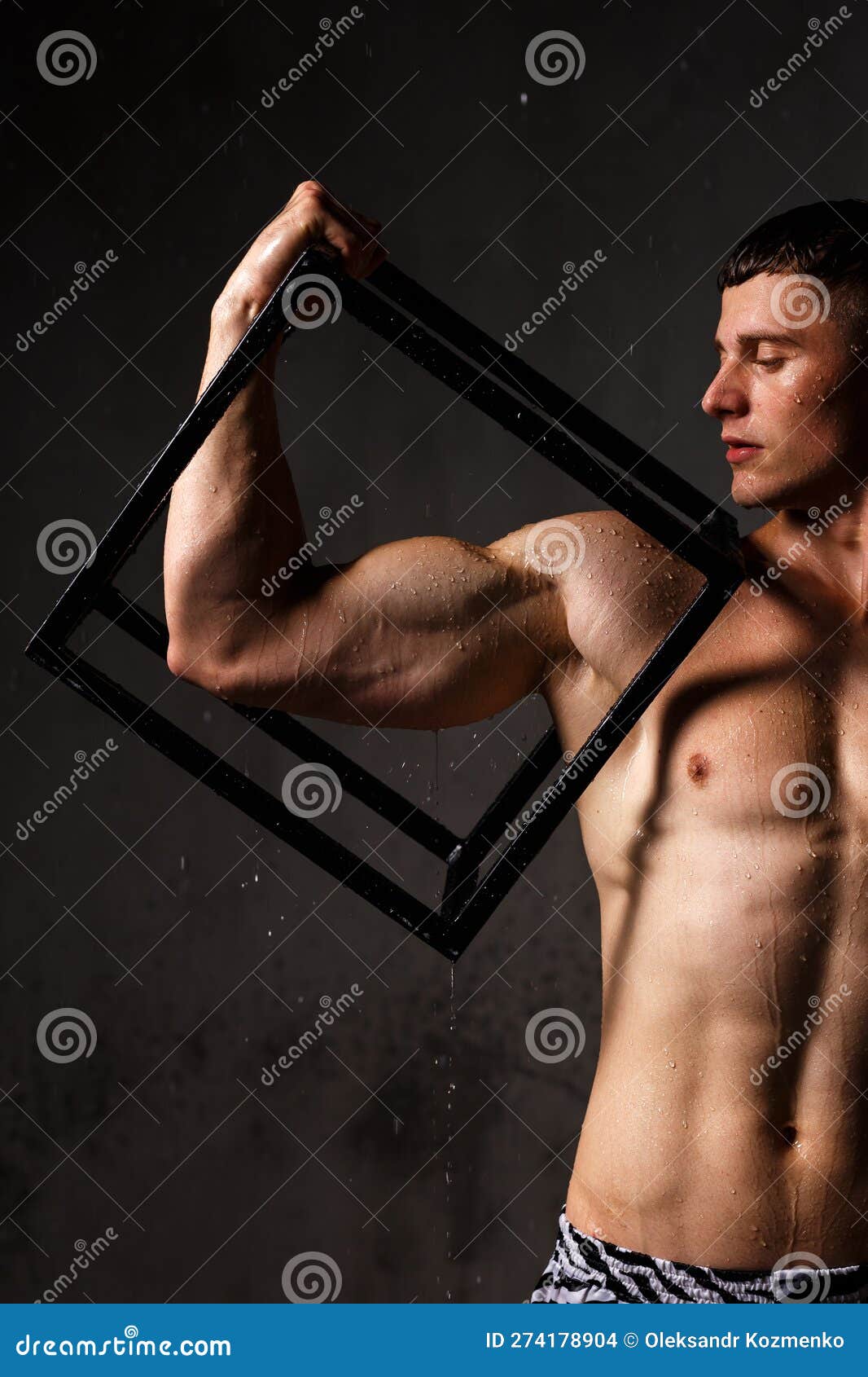 Athlete Bodybuilder Trains in the Studio in the Rain. Stock Photo ...