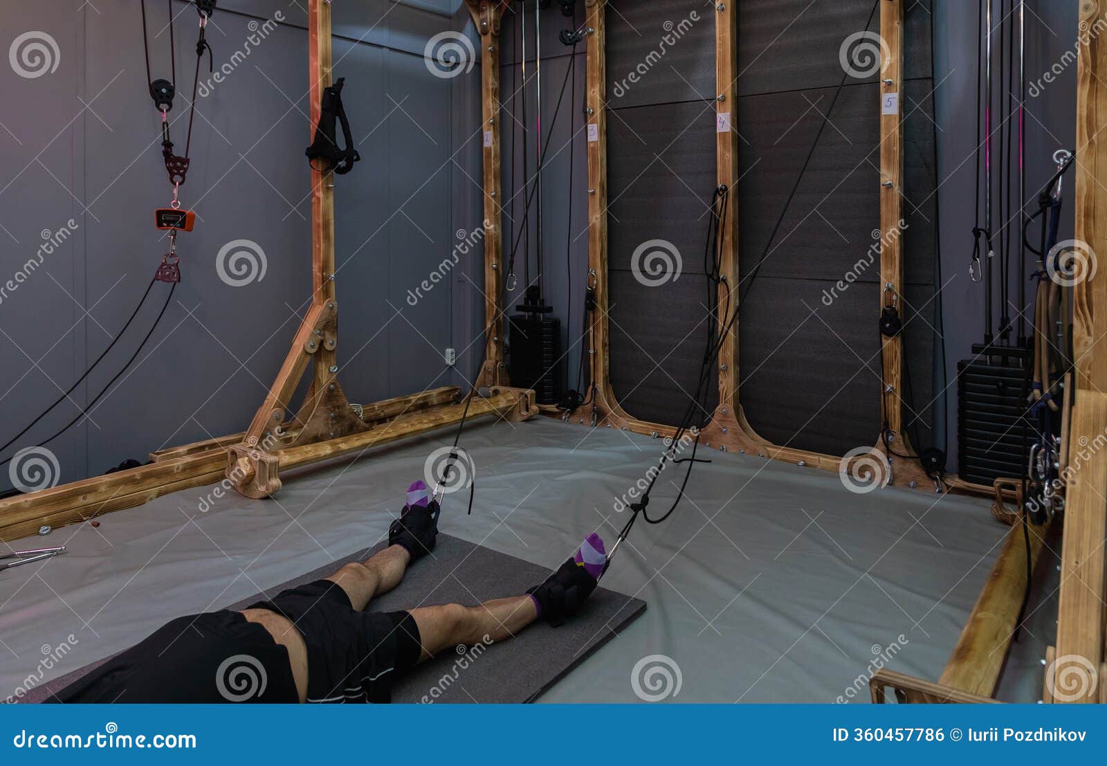 Athlete Doing Rehabilitation Exercises Using Cable Pulley Machine Stock ...