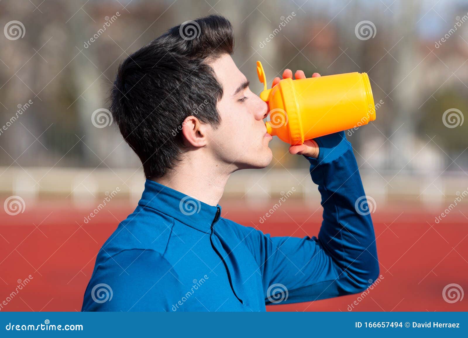 Athlete Drinking Water on a Running Track. Stock Photo - Image of ...