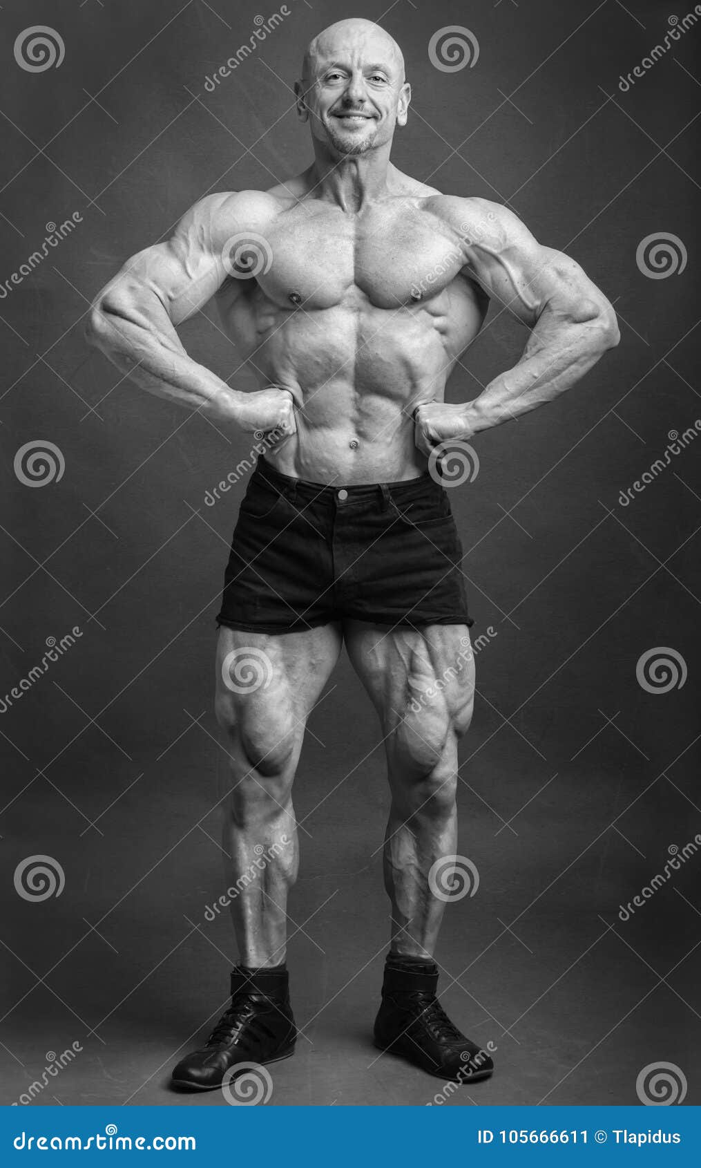 Athlete in Front Lat Spread Pose. Bodybuilder Showing Muscles on Studio ...