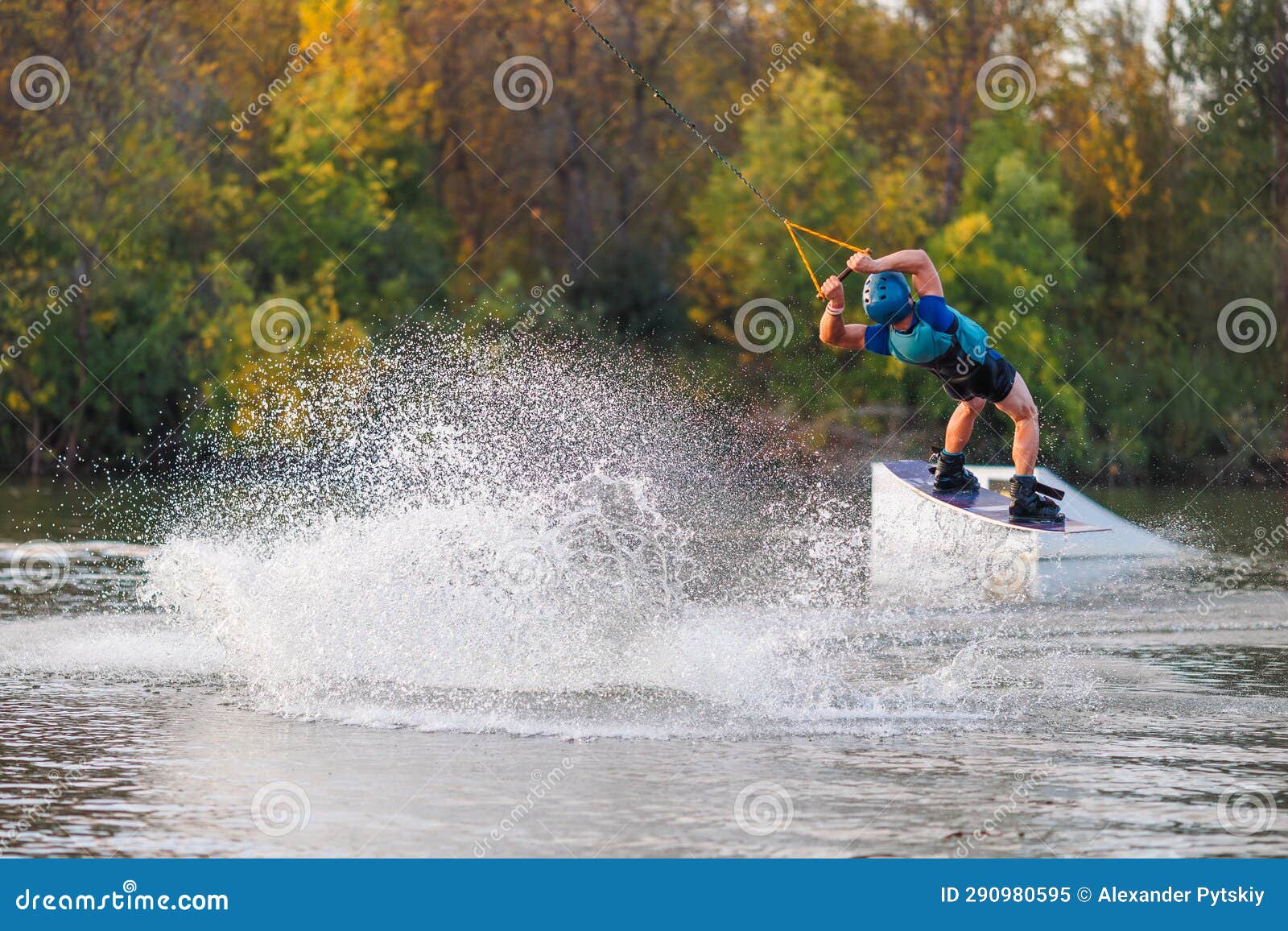 An Athlete Jumps from a Springboard. Wakeboard Park at Sunset Stock ...