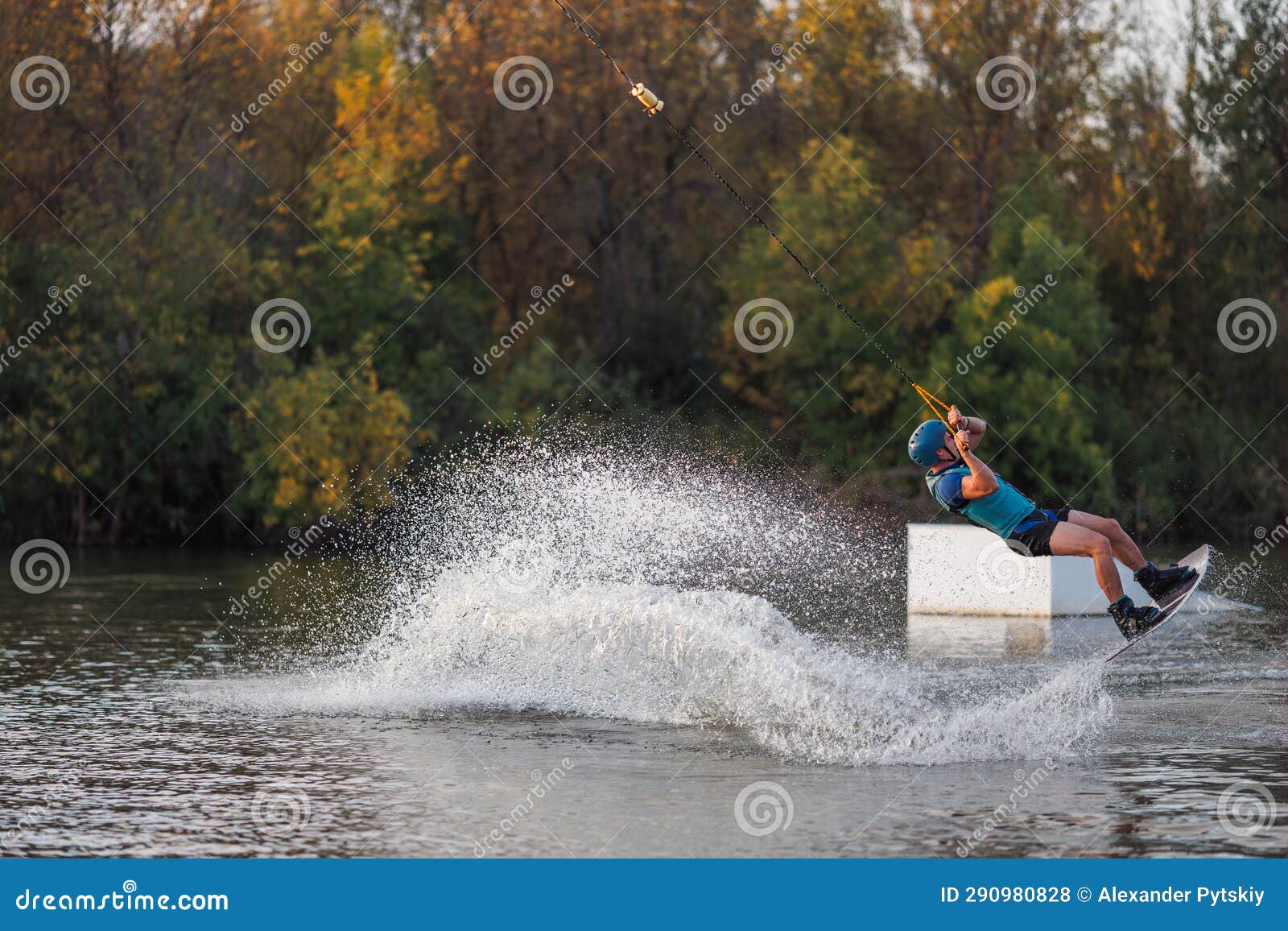 An Athlete Jumps from a Springboard. Wakeboard Park at Sunset Stock ...