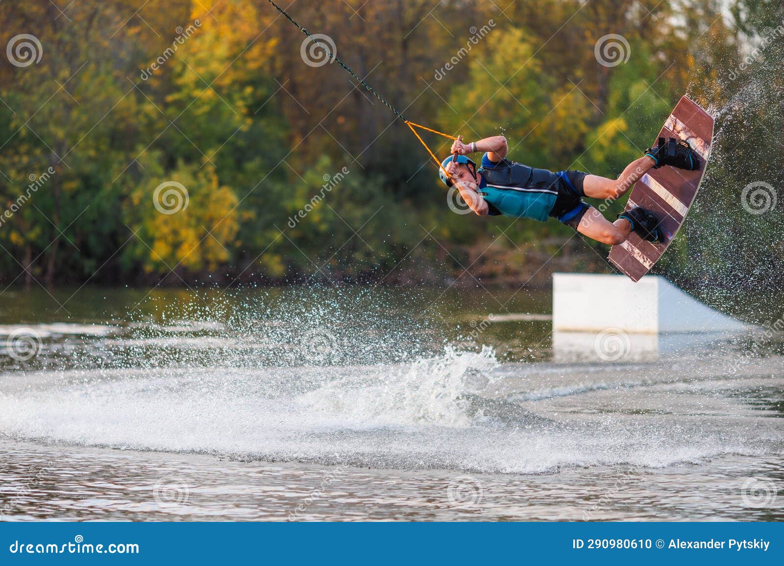 An Athlete Jumps from a Springboard. Wakeboard Park at Sunset Stock ...